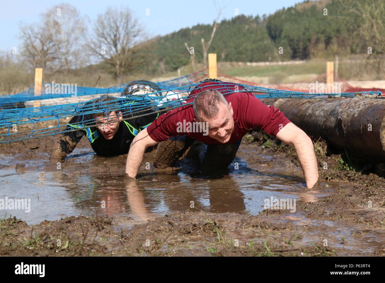 Lt. Col. Brian Carlin and 1st Lt. Jason Peck worm their way through the ...