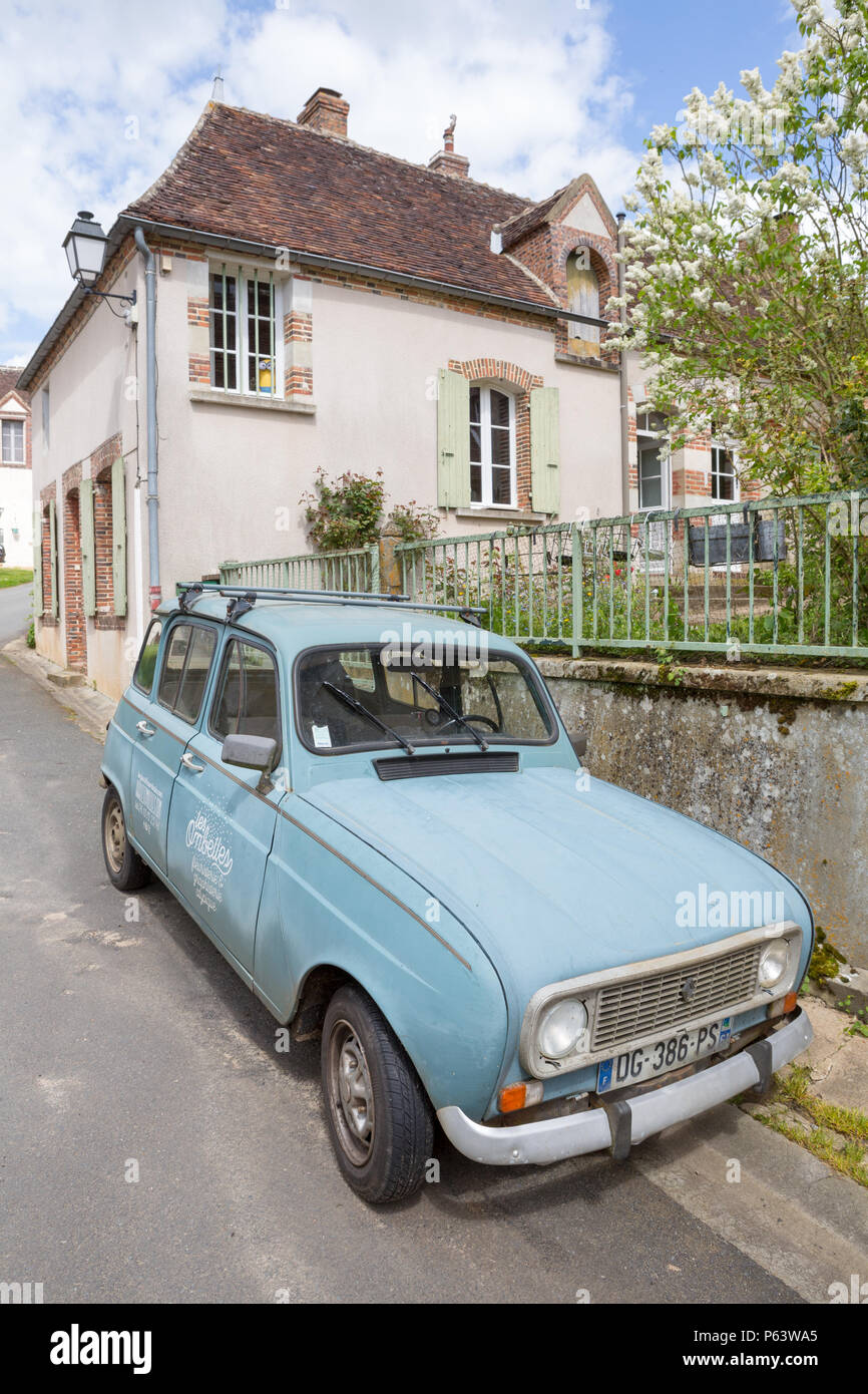 A blue classic Renault R4 parked in a french spring street in Moutiers ...