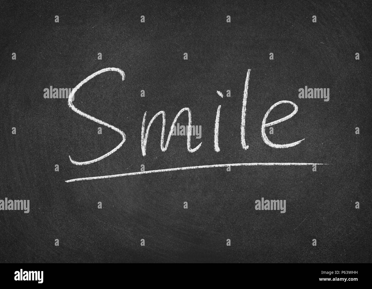 smile concept word on a blackboard background Stock Photo - Alamy