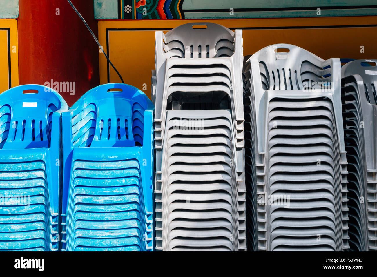 Stack of plastic chairs hi-res stock photography and images - Alamy