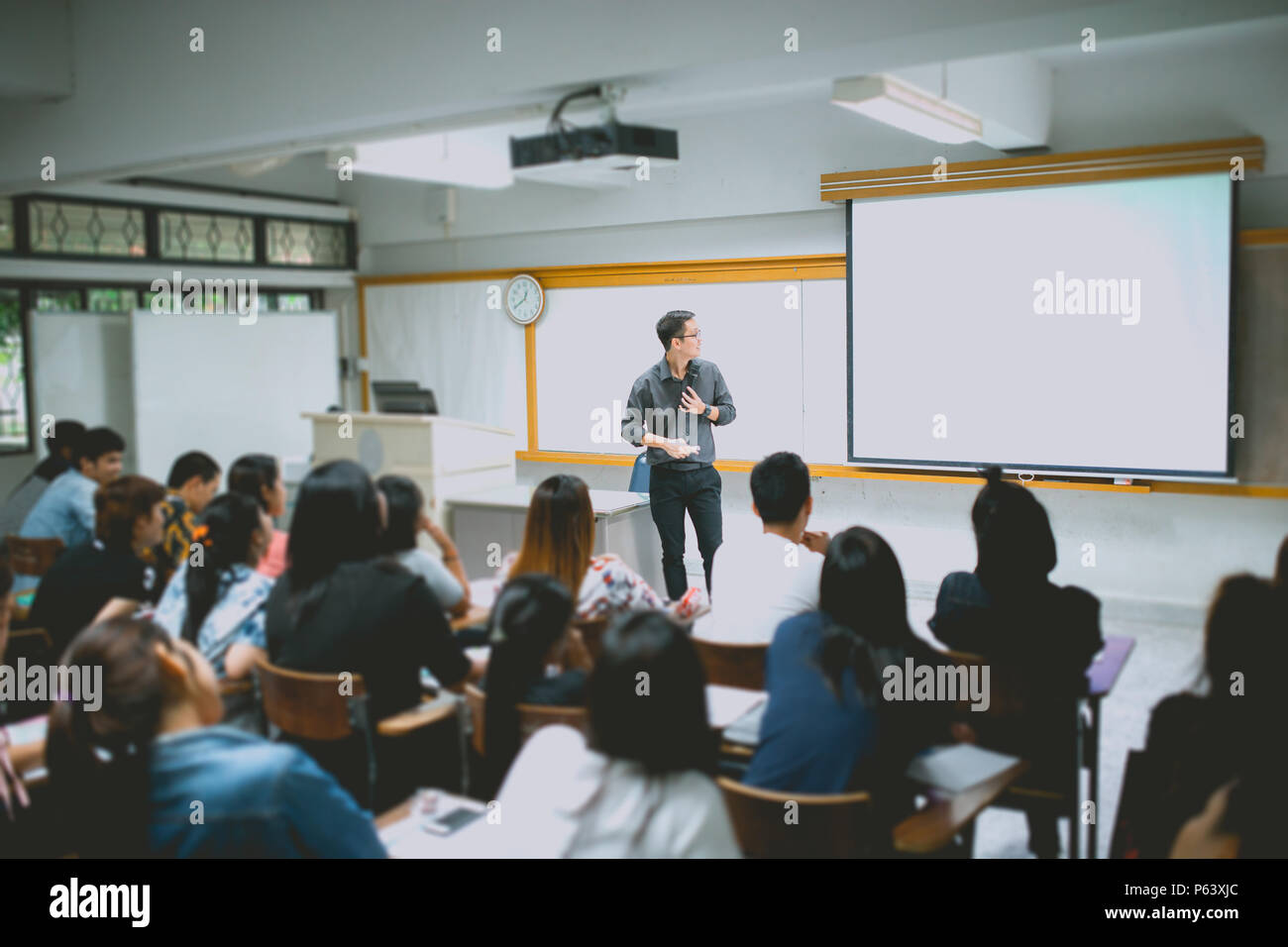 Teacher teaching studen in classroom at university Stock Photo - Alamy