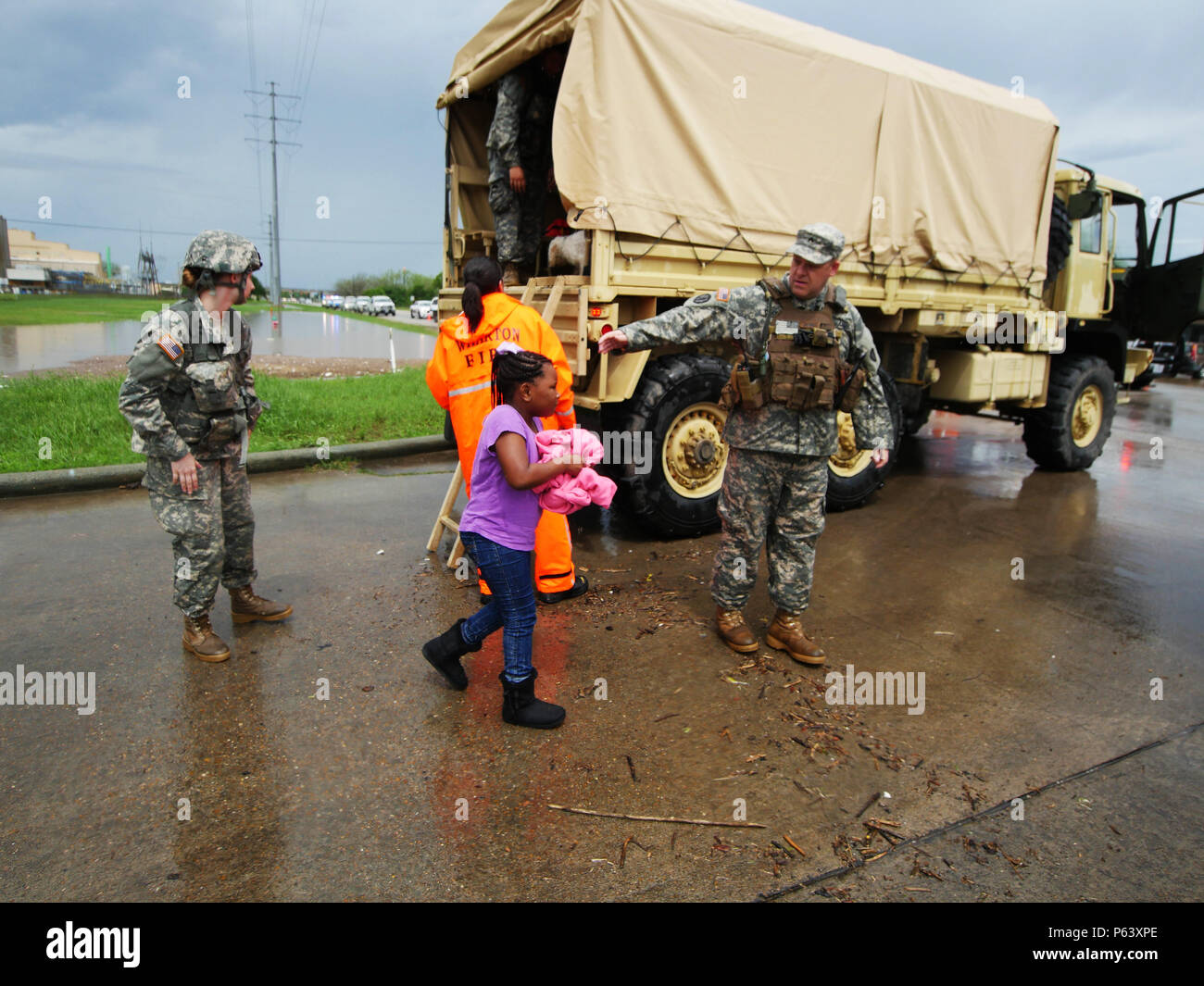 Texas Guardsmen and Texas Task Force 1 rescue personnel wade through ...