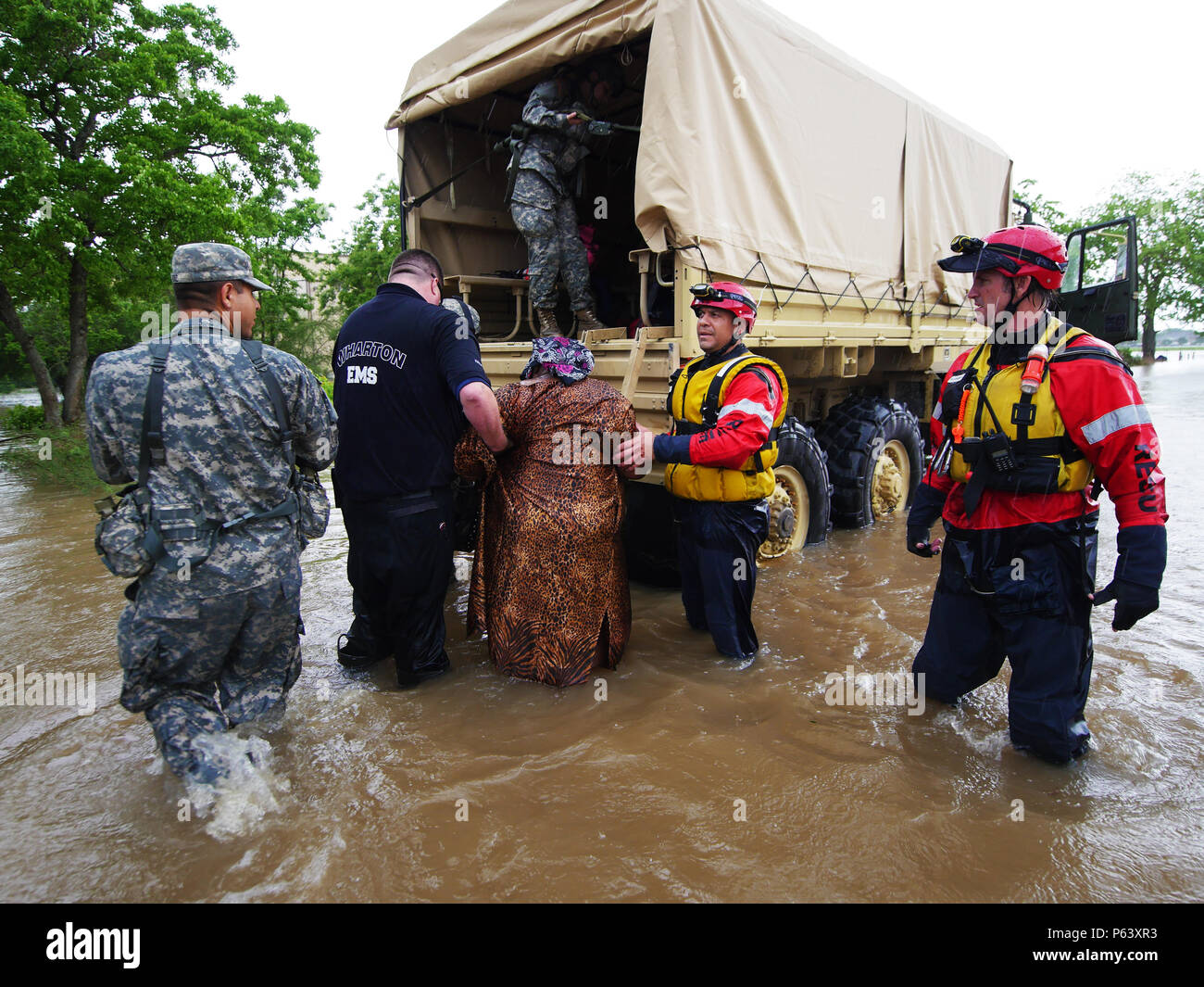 Texas Guardsmen and Texas Task Force 1 rescue personnel wade through ...