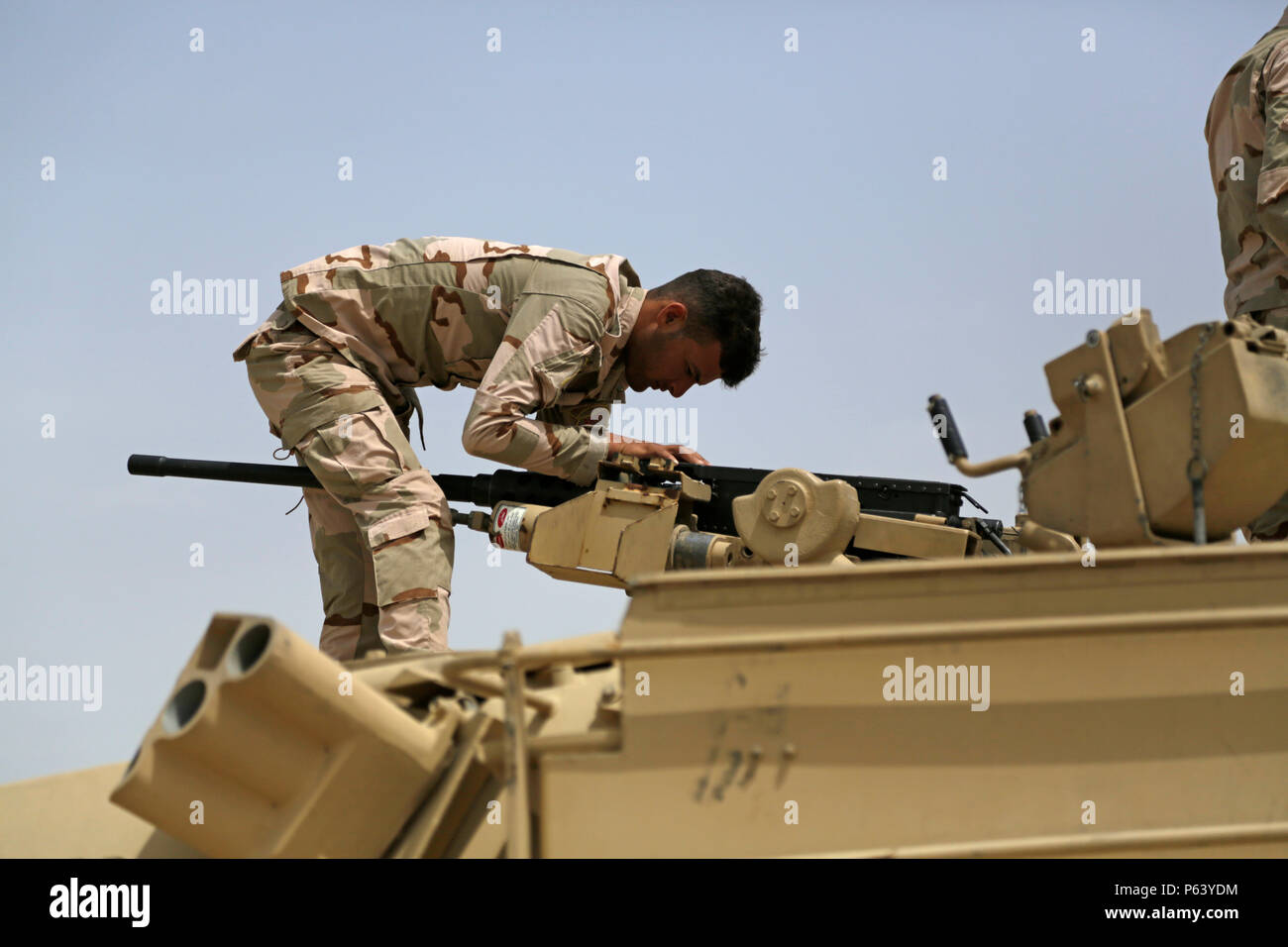 An Iraqi soldier, assigned to the 35th Iraqi Army Brigade, reattaches ...