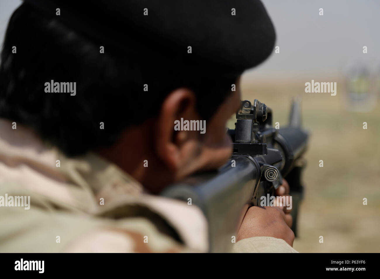 An Iraqi soldier, 35th Iraqi Army Brigade, looks through his sights ...
