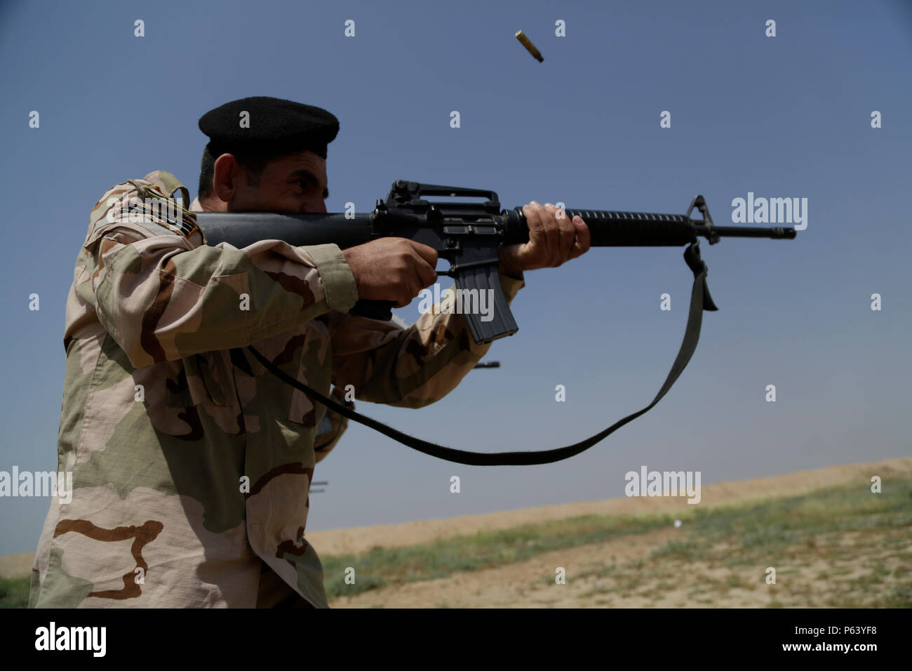 An Iraqi soldier, 35th Iraqi Army Brigade, fires at a target during M16 ...