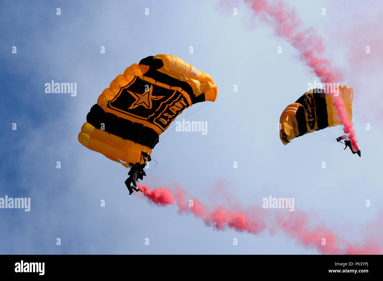 Members of the U.S. Army Golden Knights parachute team descend from a ...