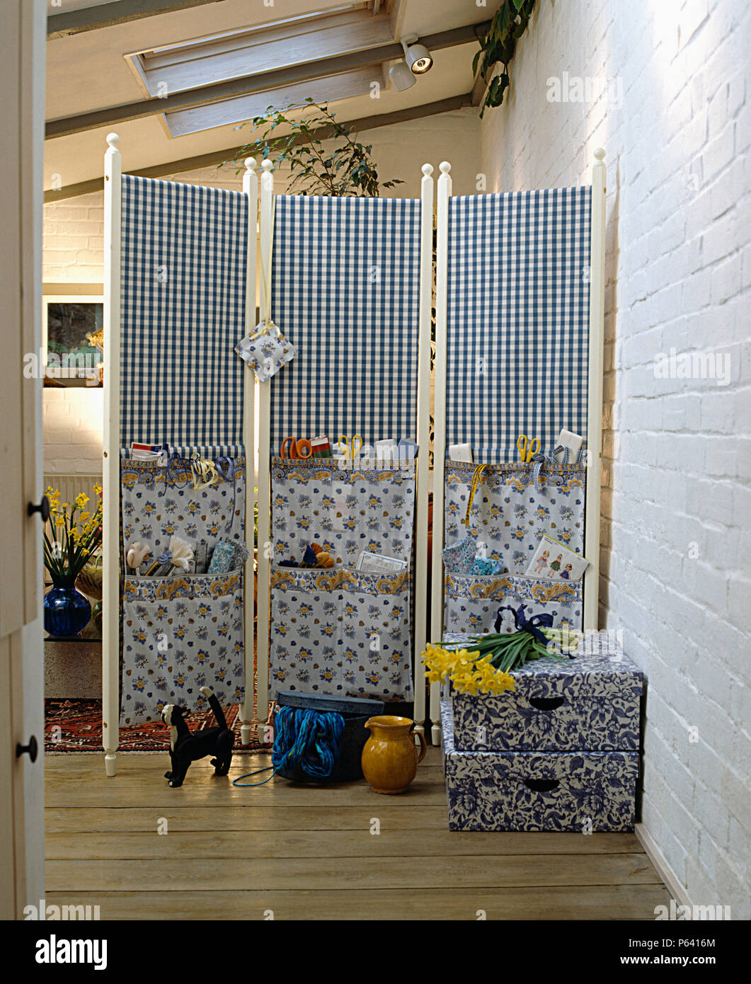 Fabric covered cardboard storage boxes in front of folding screen with ... Fabric covered cardboard storage boxes in front of folding screen with ...