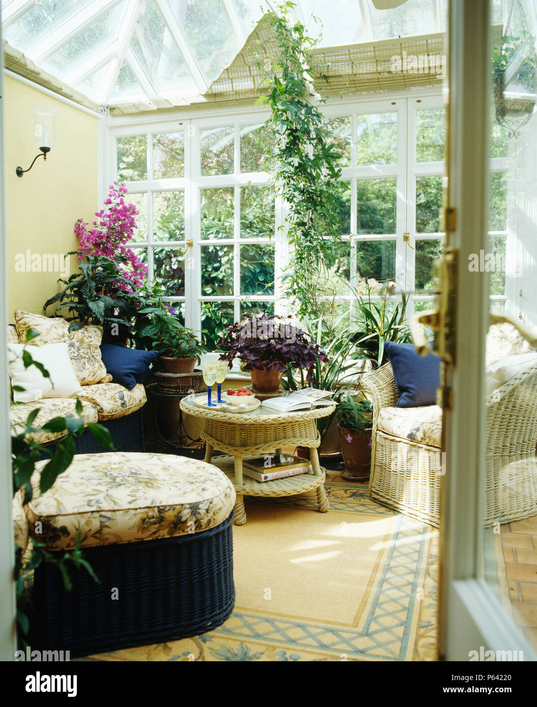 Patterned cream carpet and comfortable wicker furniture in conservatory ...