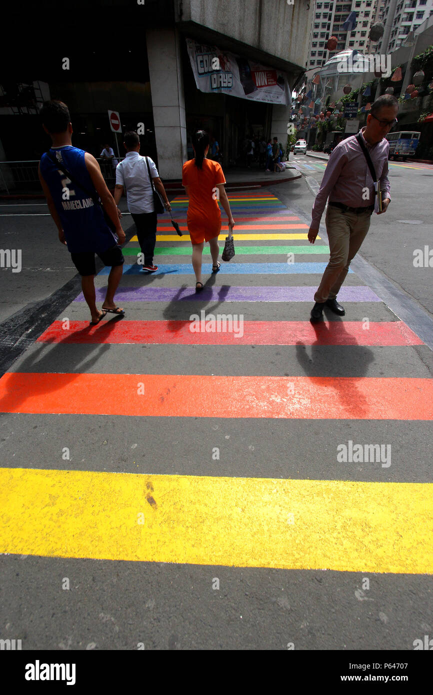 Philippines. 27th June, 2018. Street walker passing on a rainbow ...