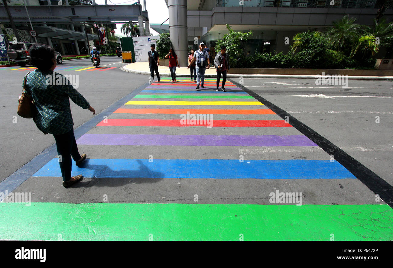 Philippines. 27th June, 2018. Street walker passing on a rainbow ...