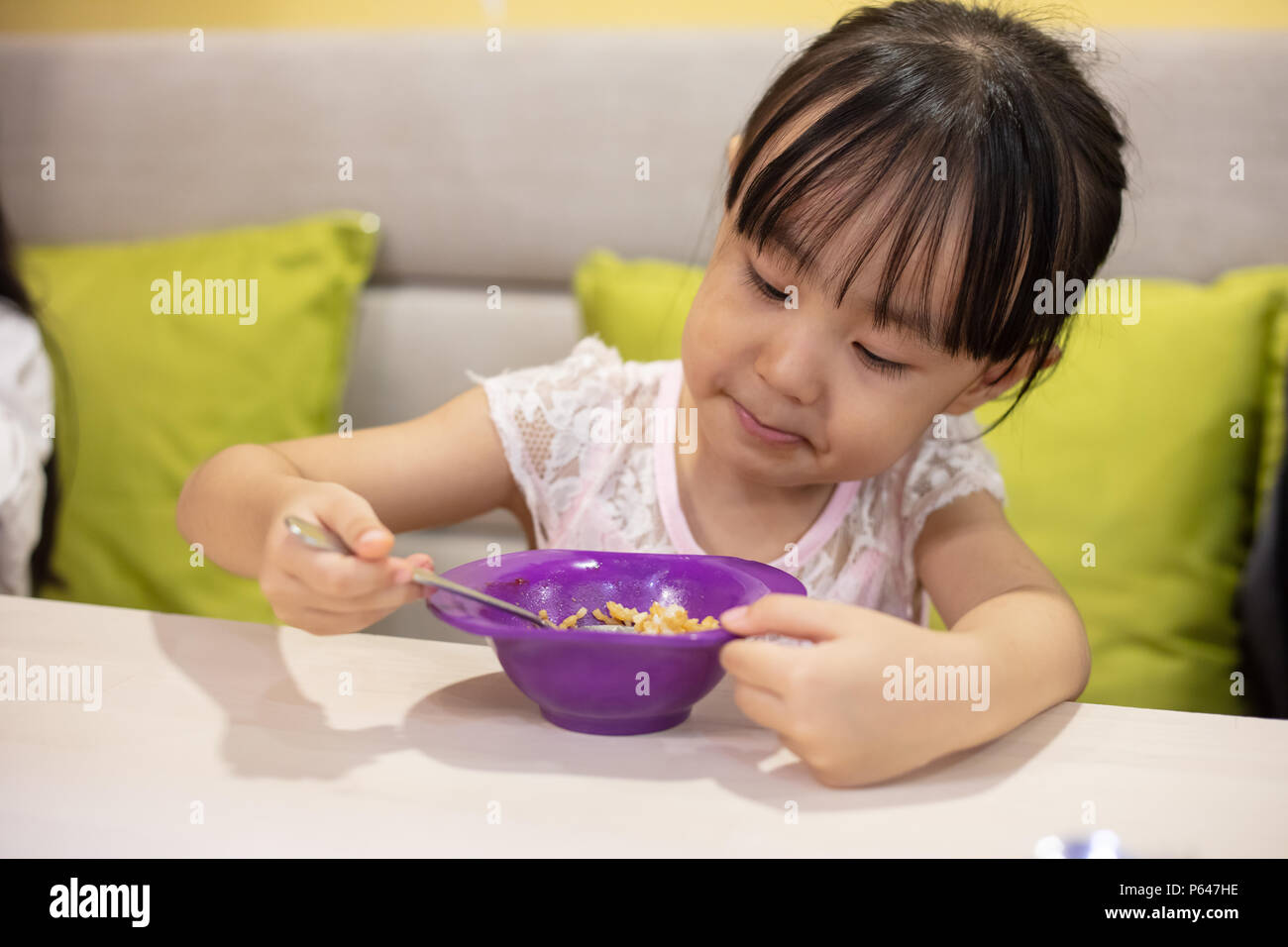 Asian Little Chinese Girl having lunch at restaurant Stock Photo - Alamy