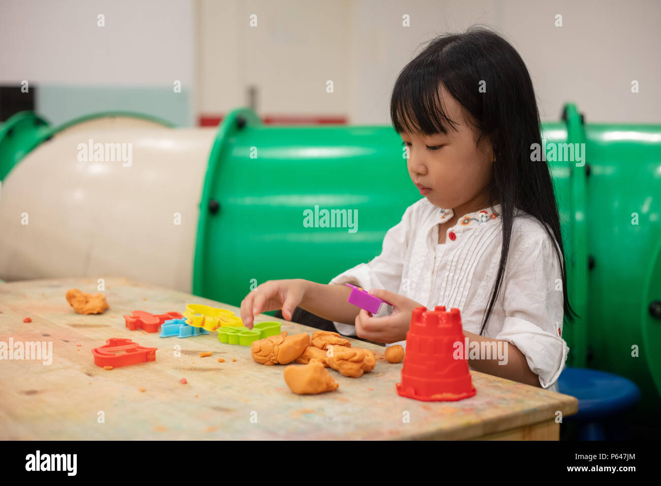Young girl playing with modeling clay hi-res stock photography and ...