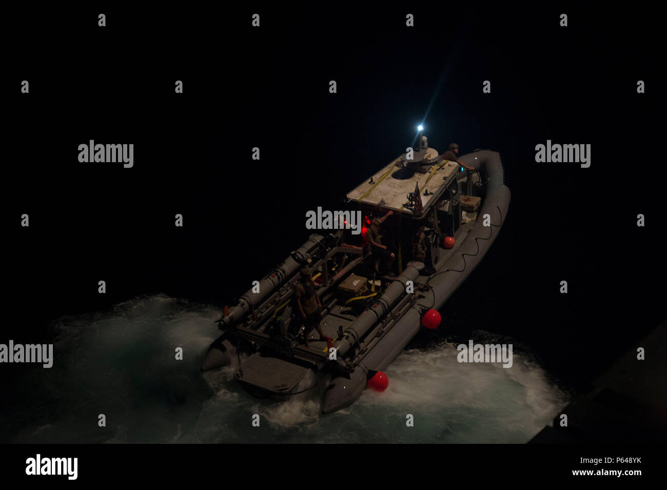 U.S. Navy Sailors, assigned to Commander, Task Group 56.1, launch an 11 ...