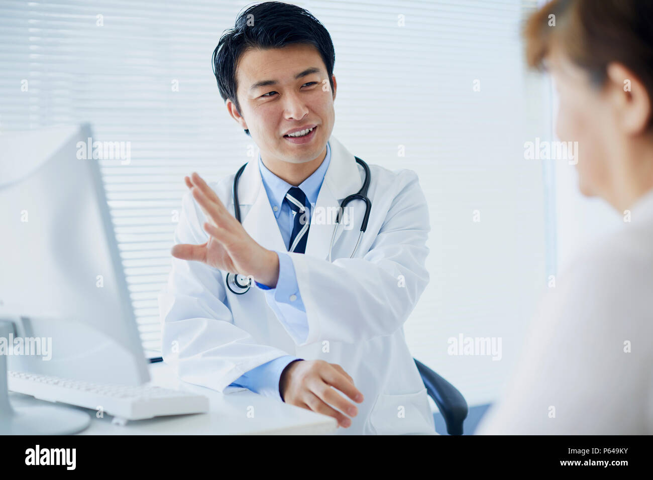 Japanese doctor with a patient in his studio Stock Photo - Alamy