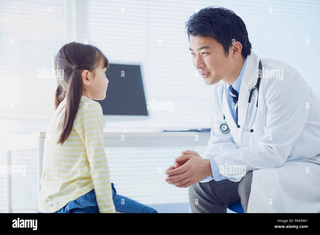 Japanese doctor with a patient in his studio Stock Photo - Alamy