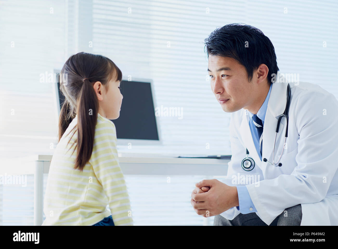 Japanese doctor with a patient in his studio Stock Photo - Alamy