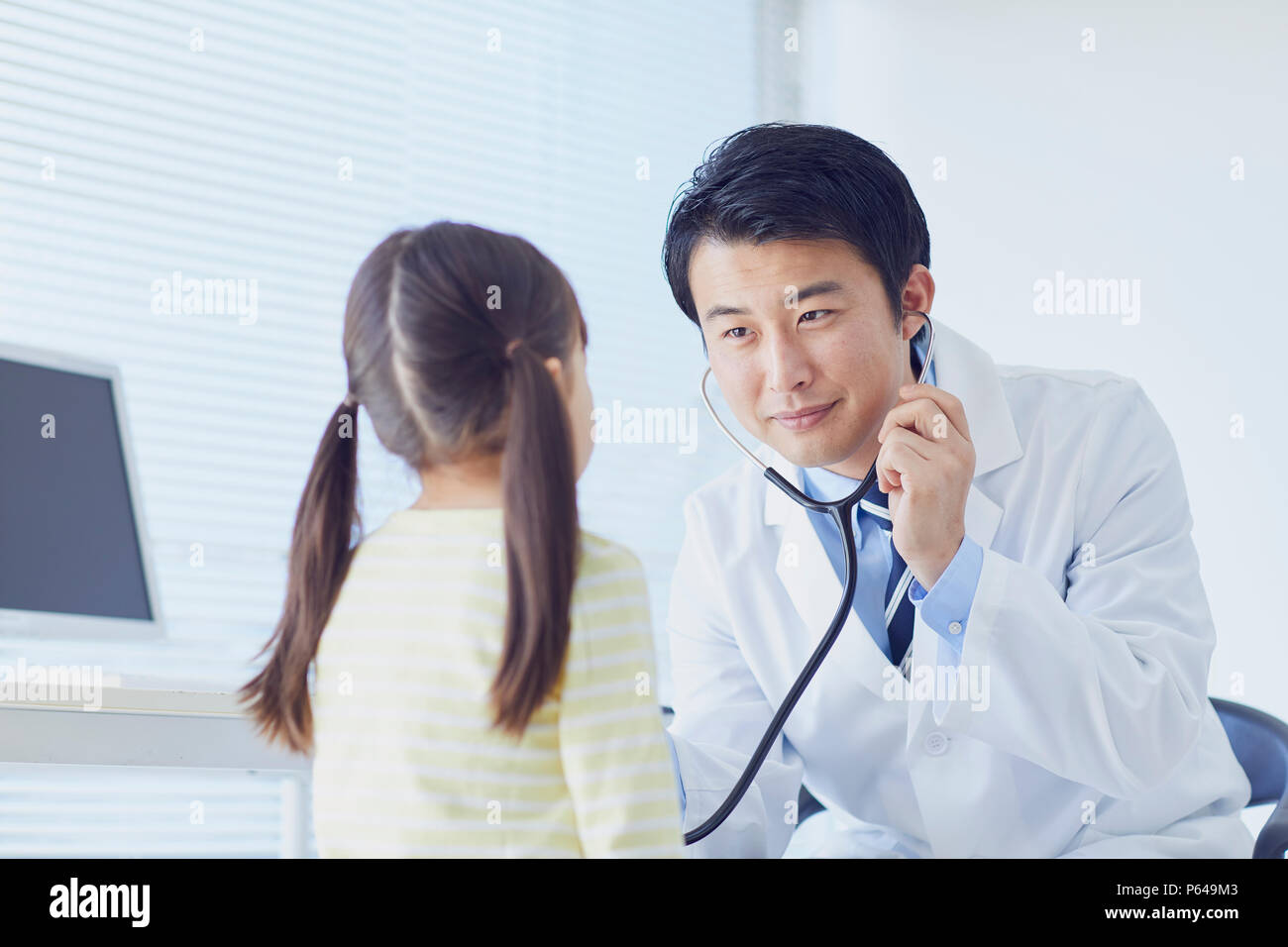 Japanese doctor with a patient in his studio Stock Photo - Alamy
