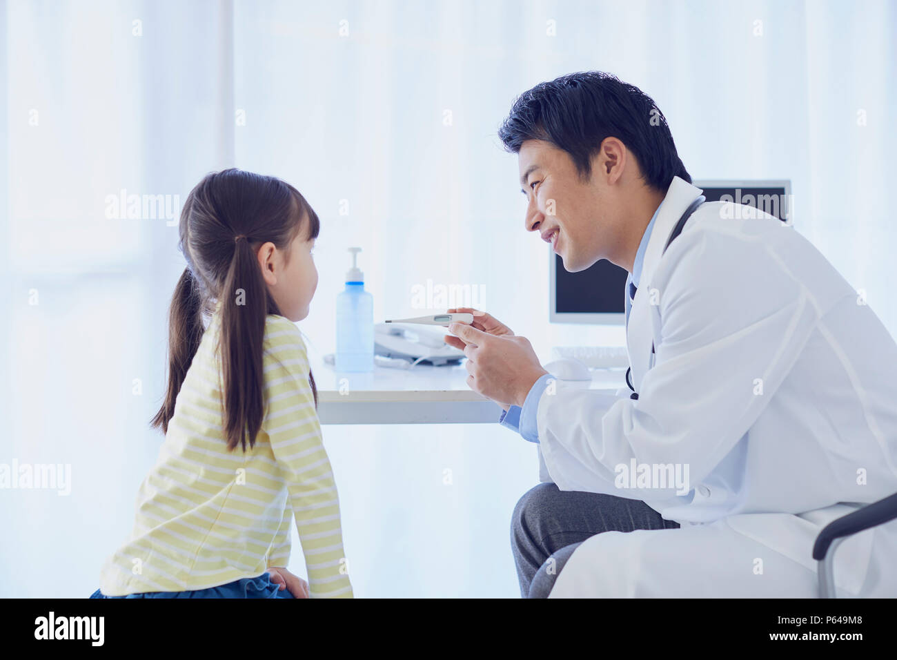 Japanese doctor with a patient in his studio Stock Photo - Alamy