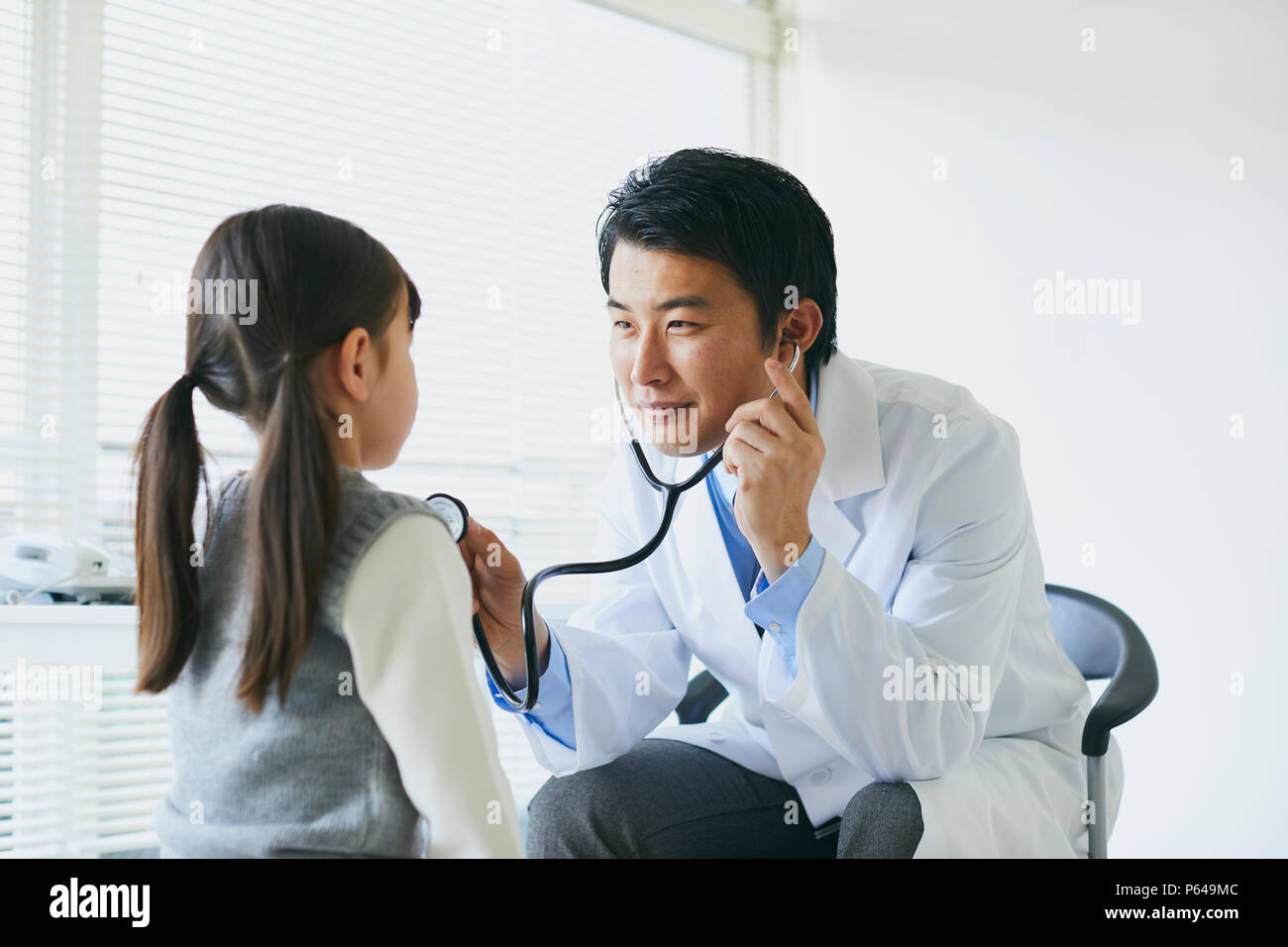 Japanese doctor with a patient in his studio Stock Photo - Alamy