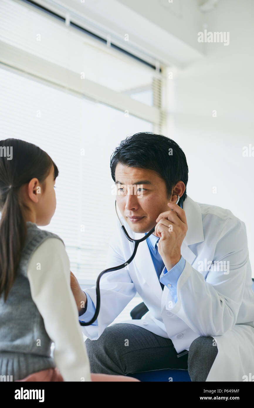 Japanese doctor with a patient in his studio Stock Photo - Alamy