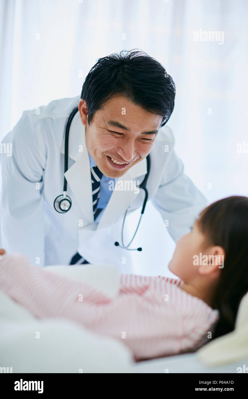 Japanese doctor with a patient in bed Stock Photo - Alamy