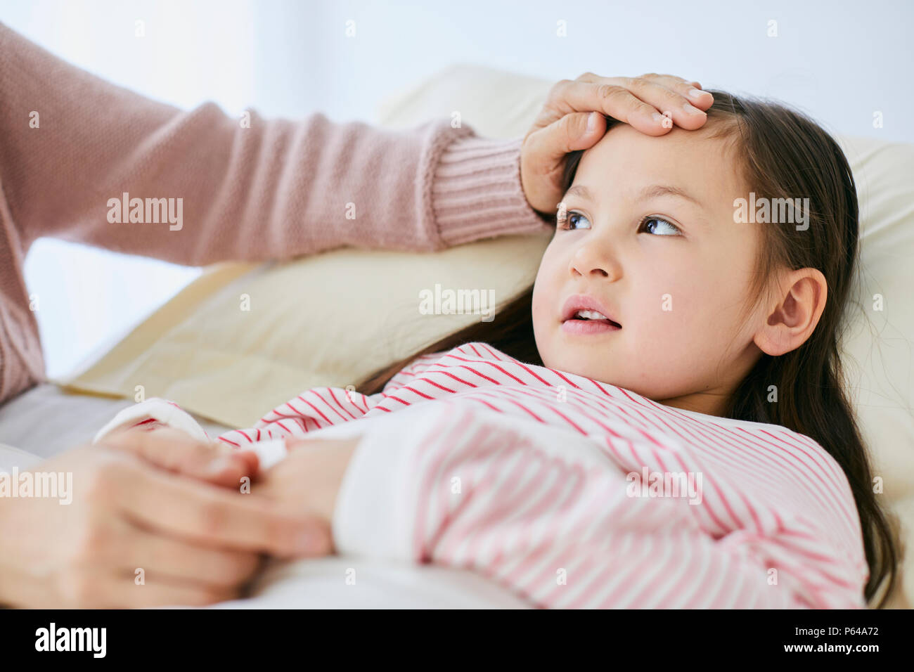 Sick Japanese kid in bed Stock Photo - Alamy