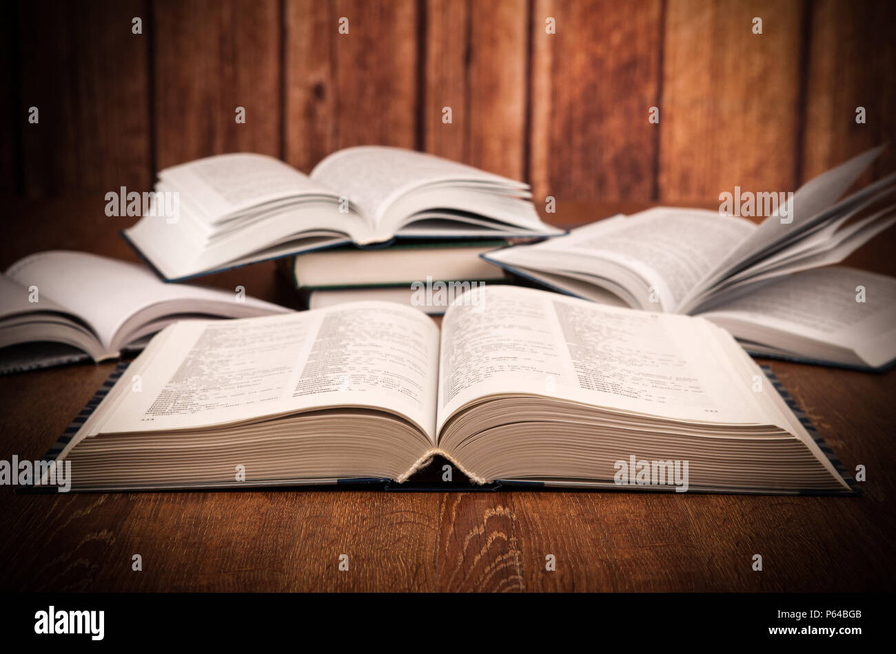 open large book on a wood table close up Stock Photo - Alamy