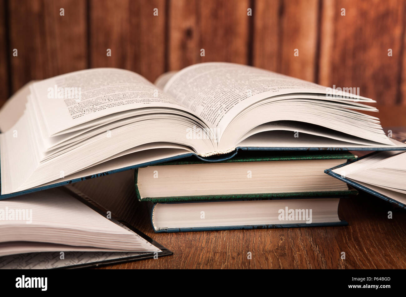 stack of books on a wood background Stock Photo - Alamy