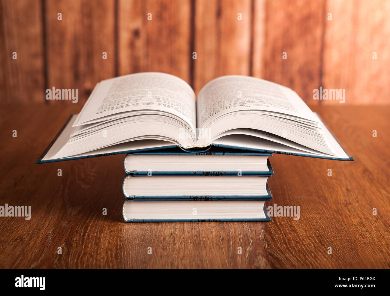 stack of books on a wood background Stock Photo - Alamy