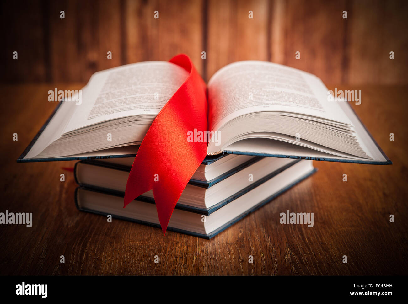 stack of books with bookmark on a wood background Stock Photo - Alamy