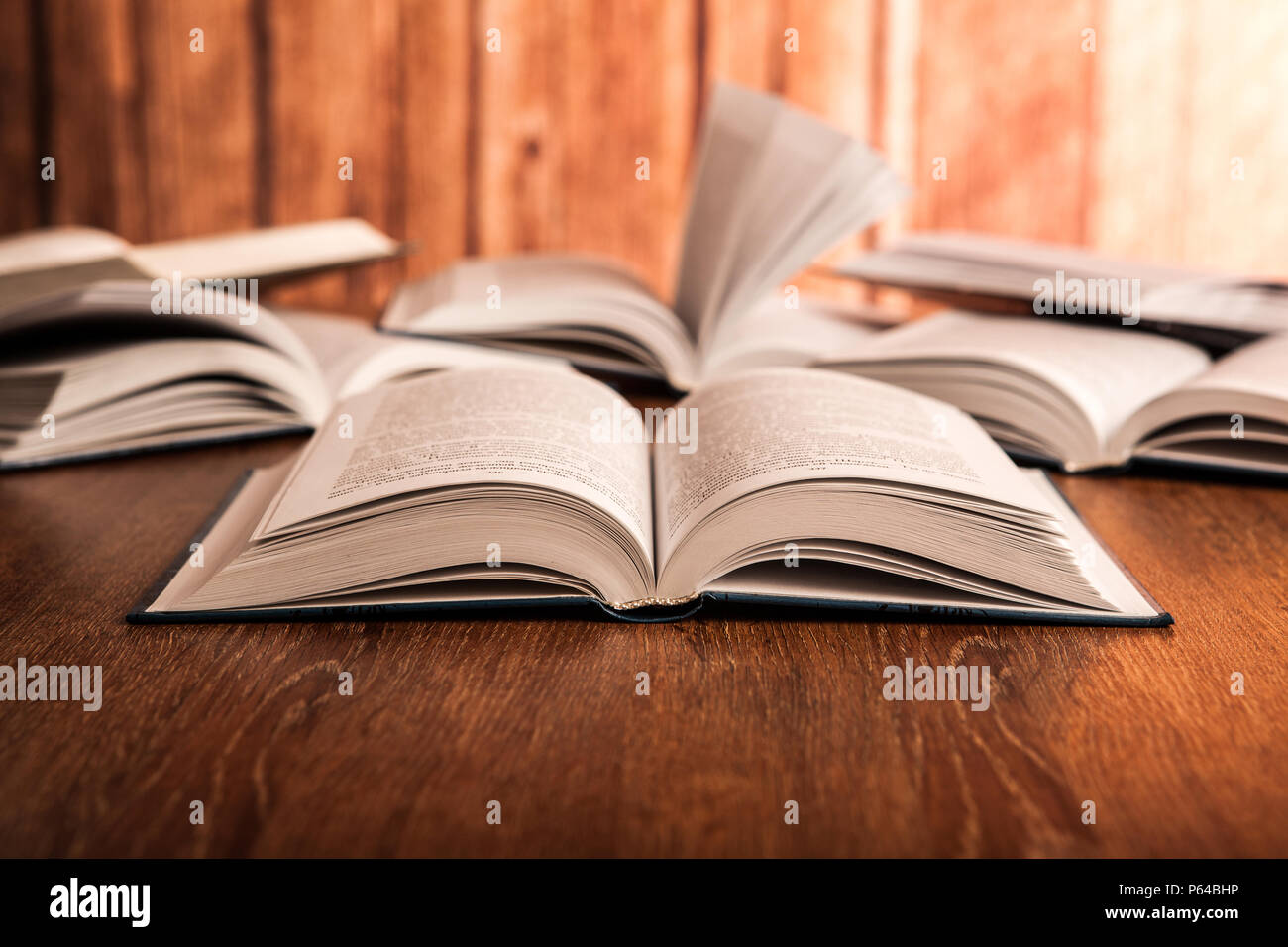 open large book on a wood table close up Stock Photo - Alamy