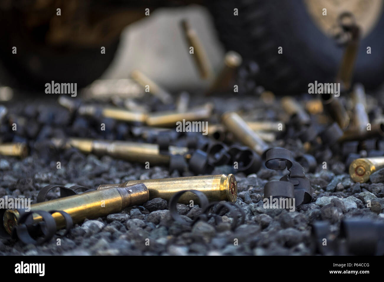 Expended .50 Caliber shells and links lay scattered on the ground as ...