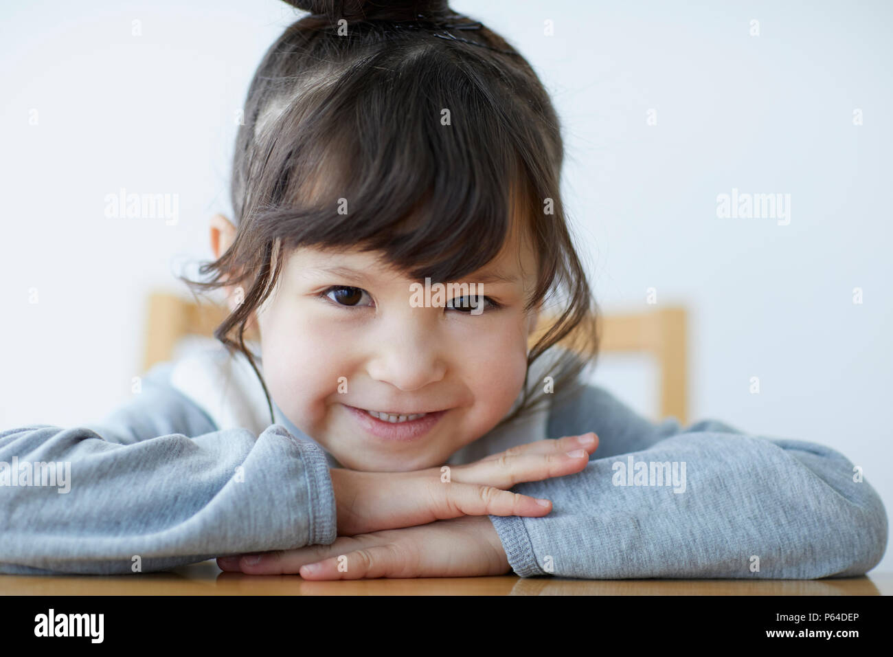 Cute girl leaning on table hi-res stock photography and images - Alamy