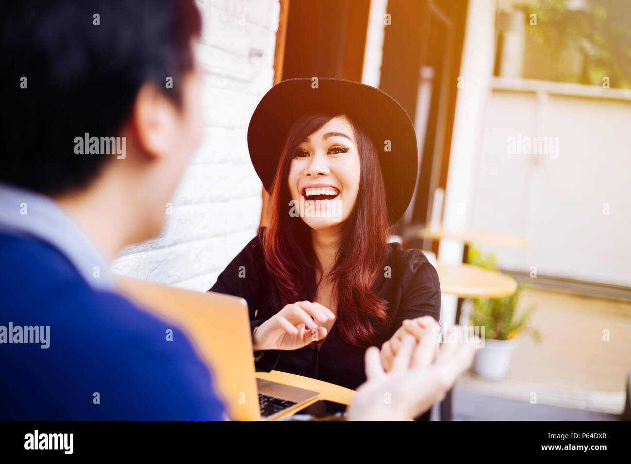 Young happy business woman discussing a business talk with partner at ...