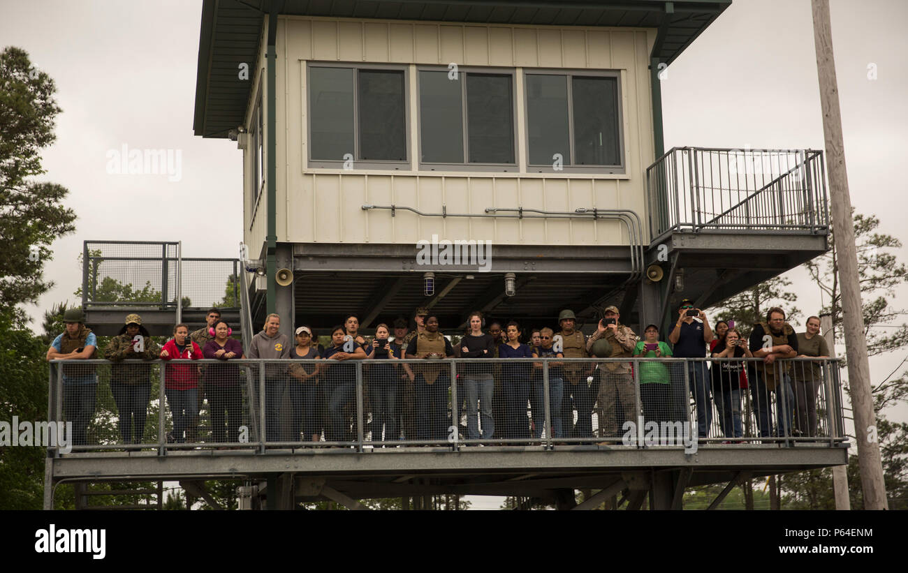 Observing from a safe distance, family members and spouses observe the ...