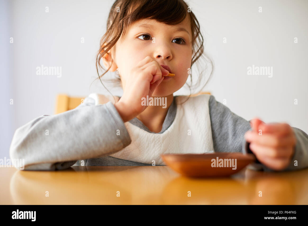 Cute Japanese kid having a snack Stock Photo - Alamy