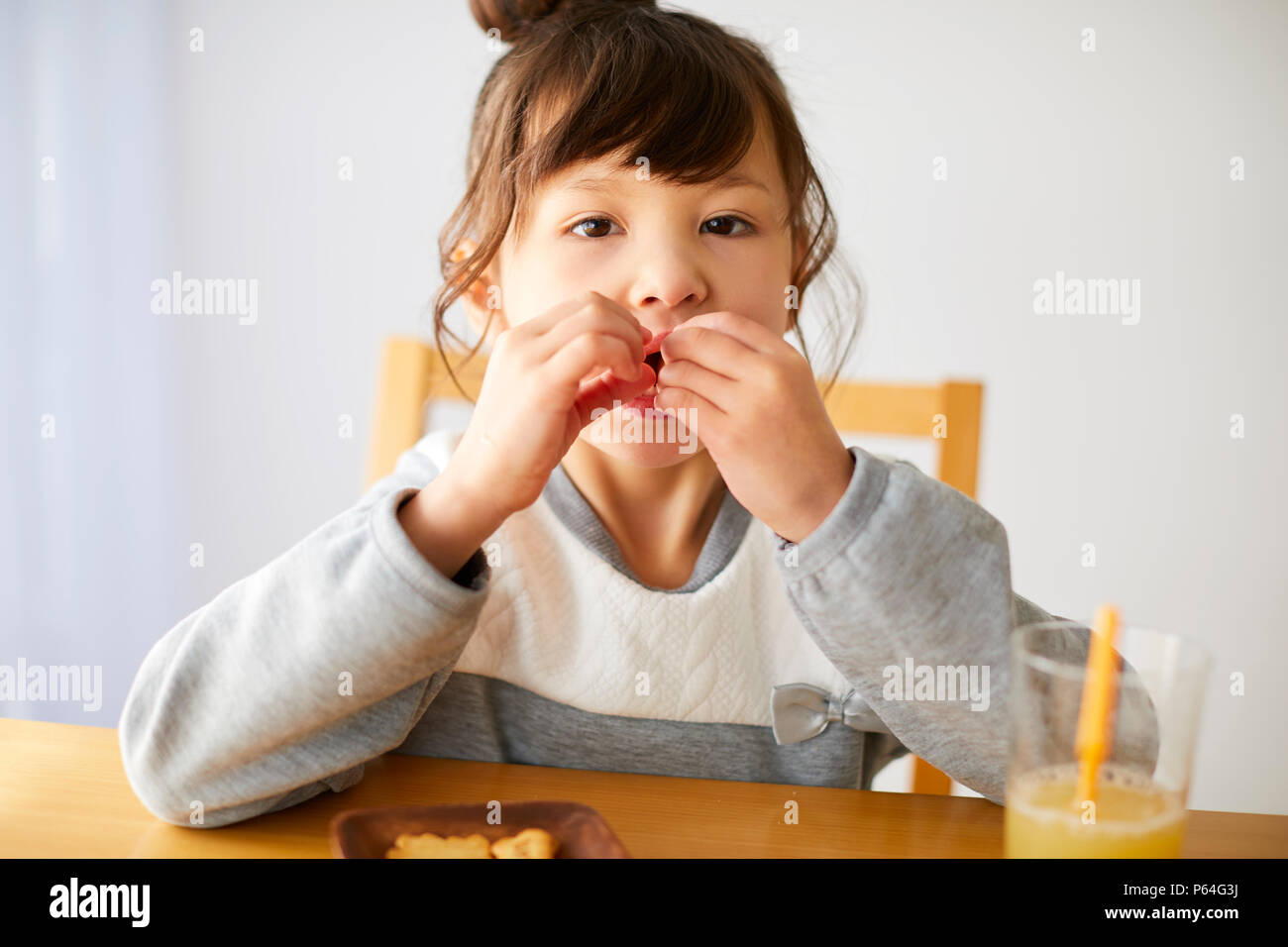 Cute Japanese kid having a snack Stock Photo - Alamy