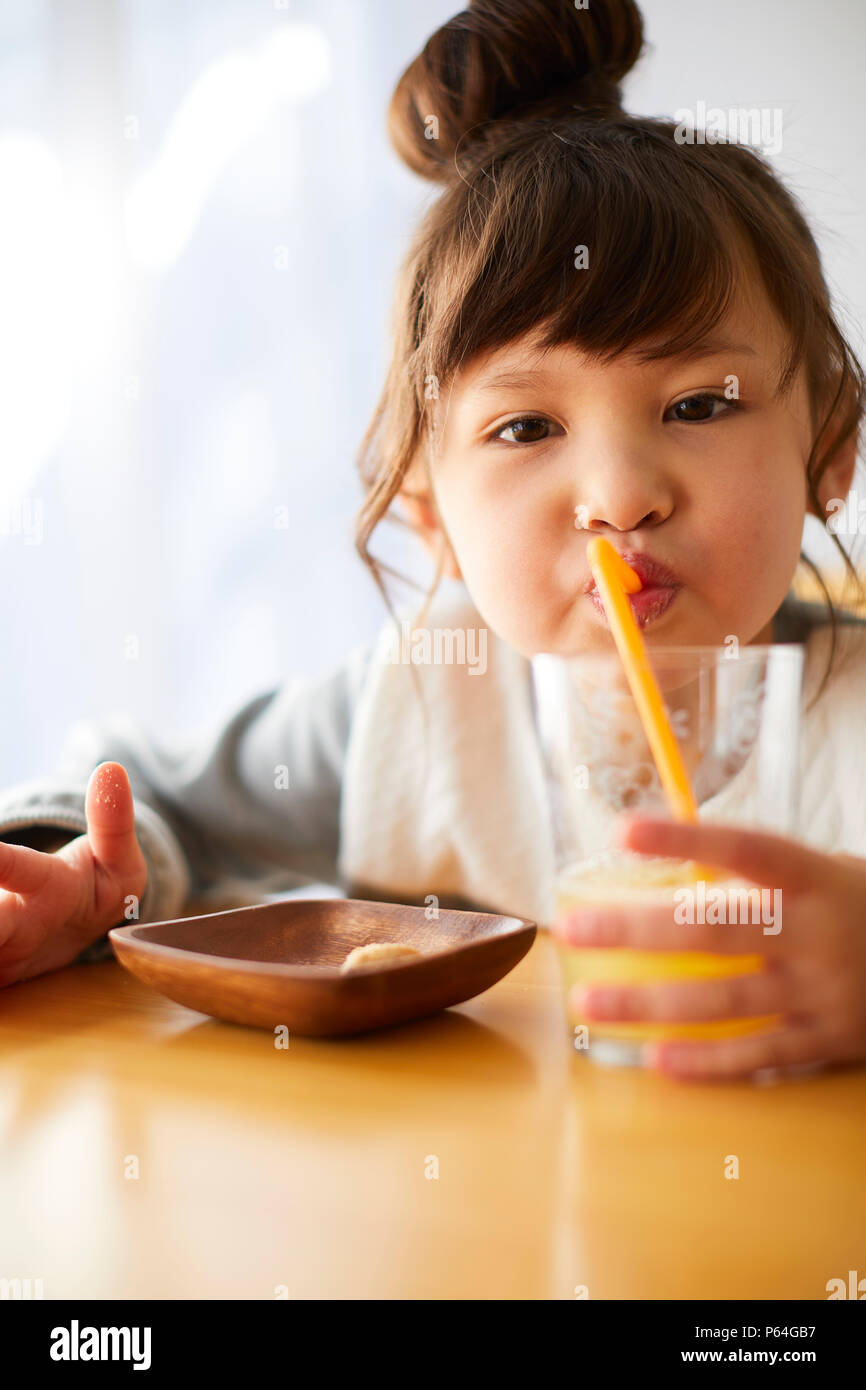 Cute Japanese kid having a snack Stock Photo - Alamy