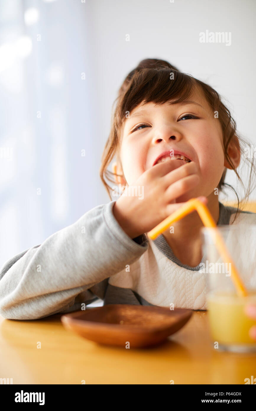Cute Japanese kid having a snack Stock Photo - Alamy