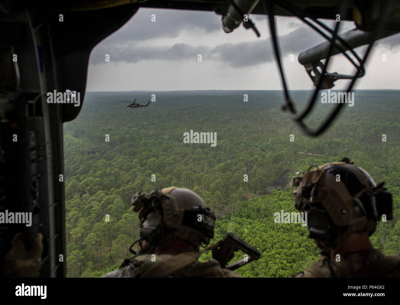 U.S. Army Special Forces team members fly on UH-60 Black Hawks flown by ...