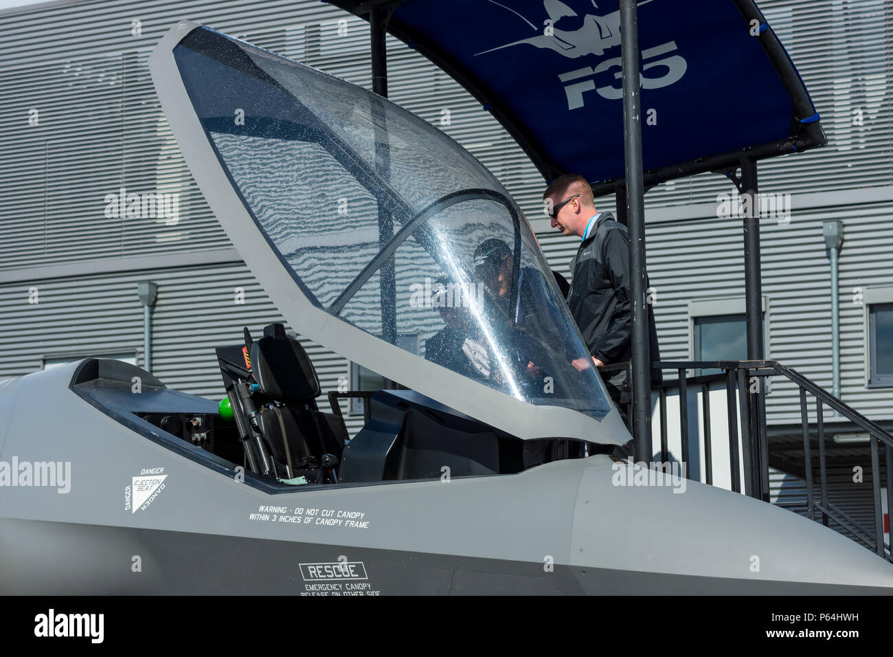 Visitors look at the cockpit of the stealth multirole fighter Lockheed ...