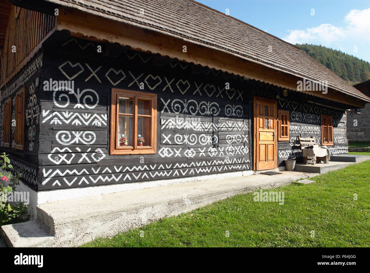 Traditional wooden cottage with the famous white painted symbolism of ...