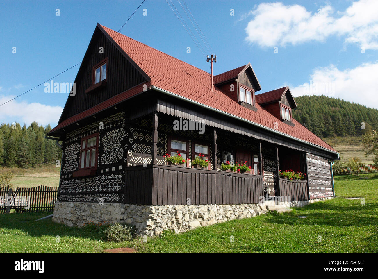 Traditional wooden cottage with the famous white painted symbolism of ...