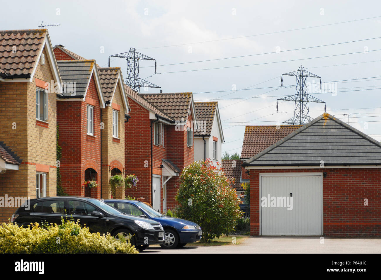 New housing estate with electric pylons in the background Stock Photo ...