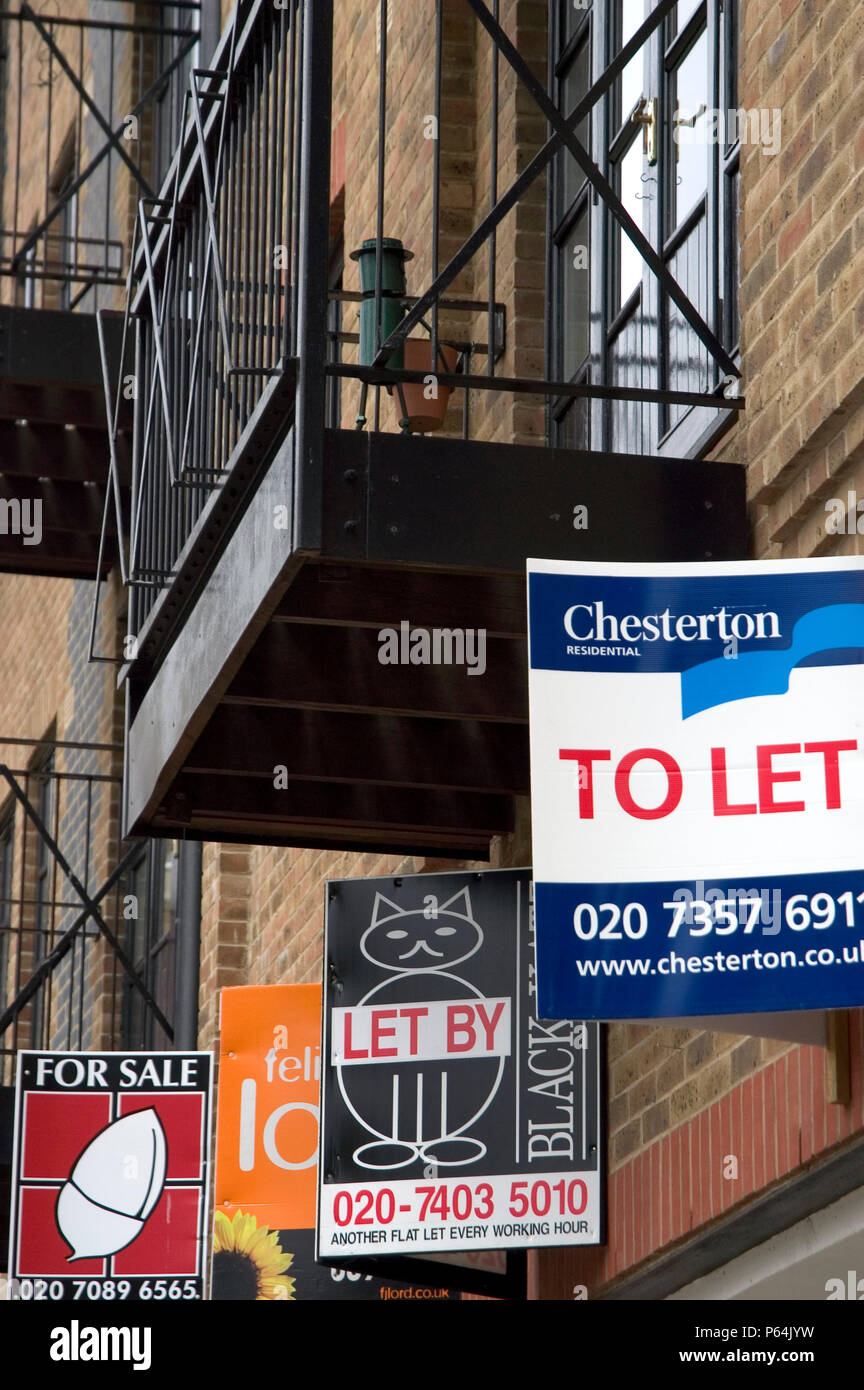 Estate agent letting and selling boards mounted on the exterior of ...