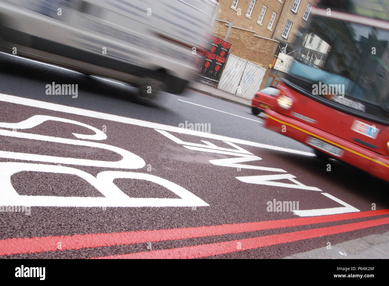 Red bus rushing down a bus lane in Central London Stock Photo - Alamy