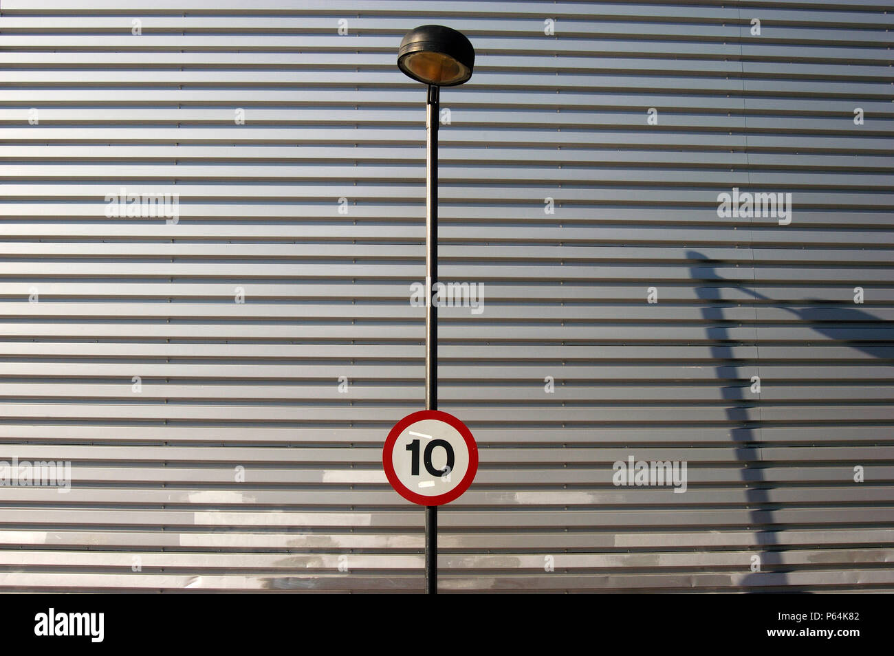 Speed limit sign around an exterior of a warehouse Stock Photo - Alamy