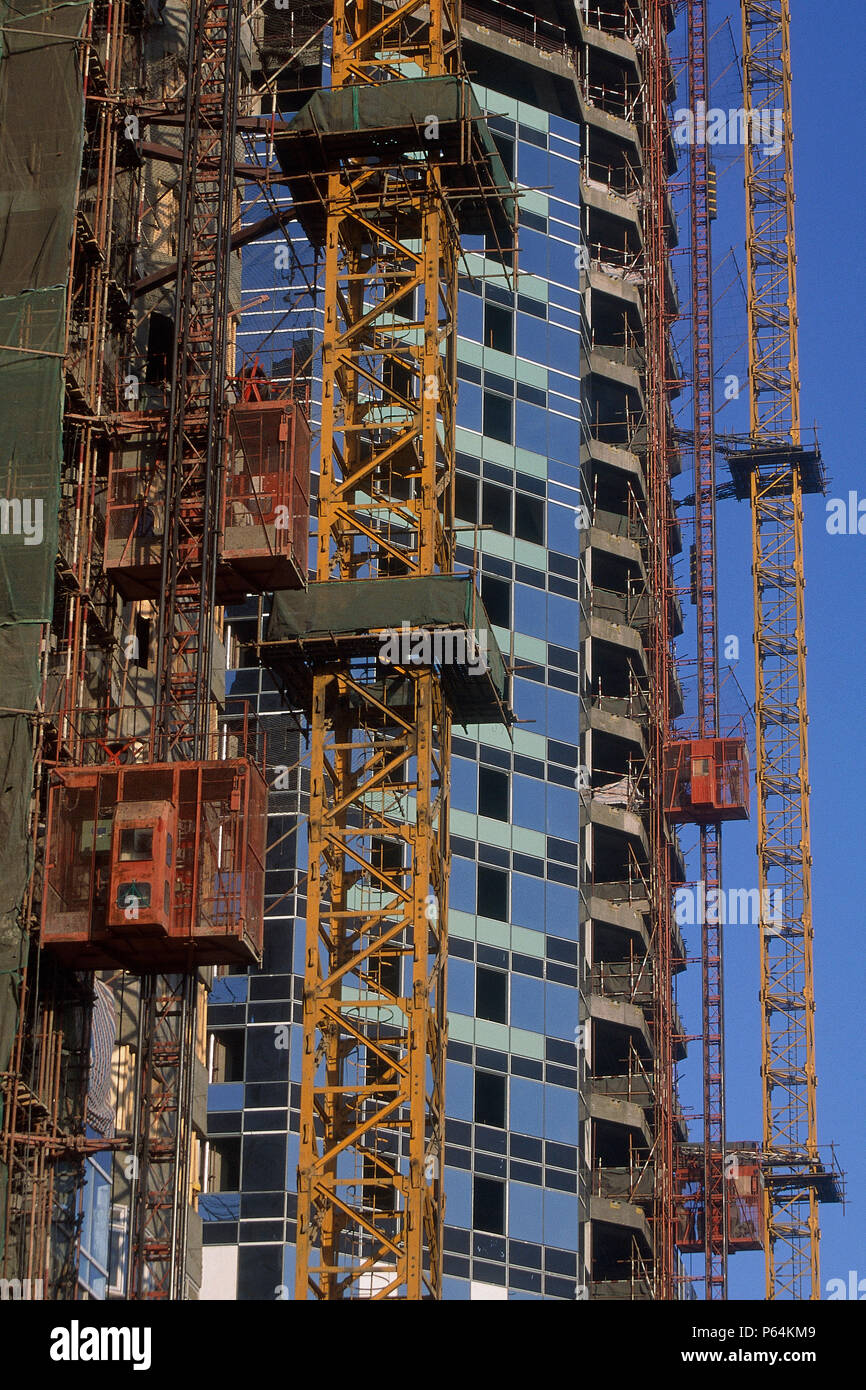 Multiple hoists on the outside of a new tower block office development ...