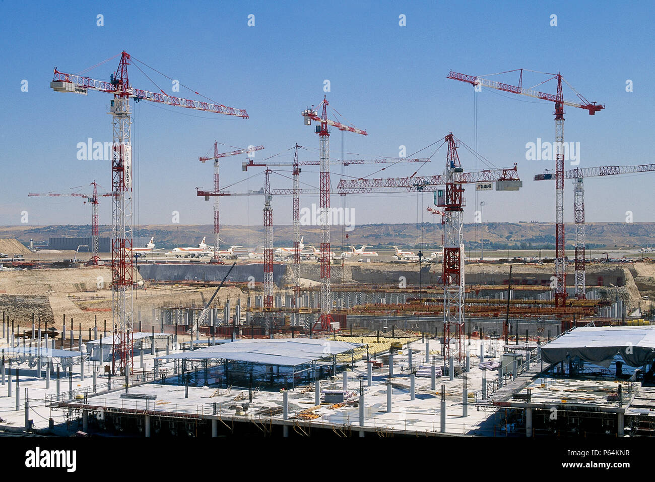 Multiple tower cranes on construction site adjacent to Madrid Baracas ...